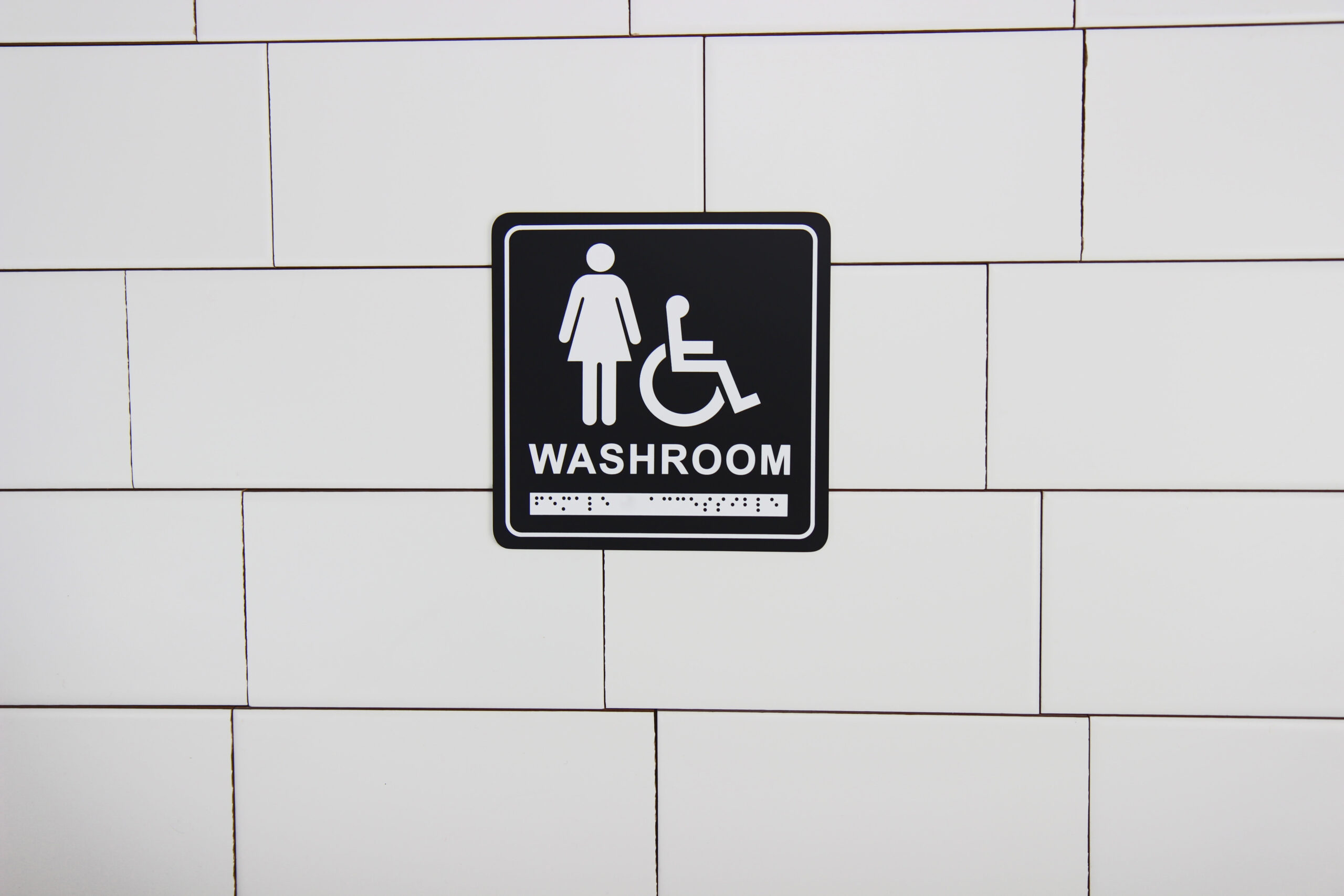 Washroom Signage – Female/Wheelchair with Braille Emboss – Frost